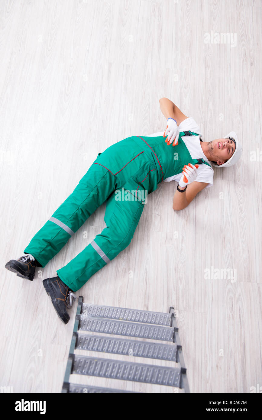 Young worker falling from the ladder Stock Photo - Alamy