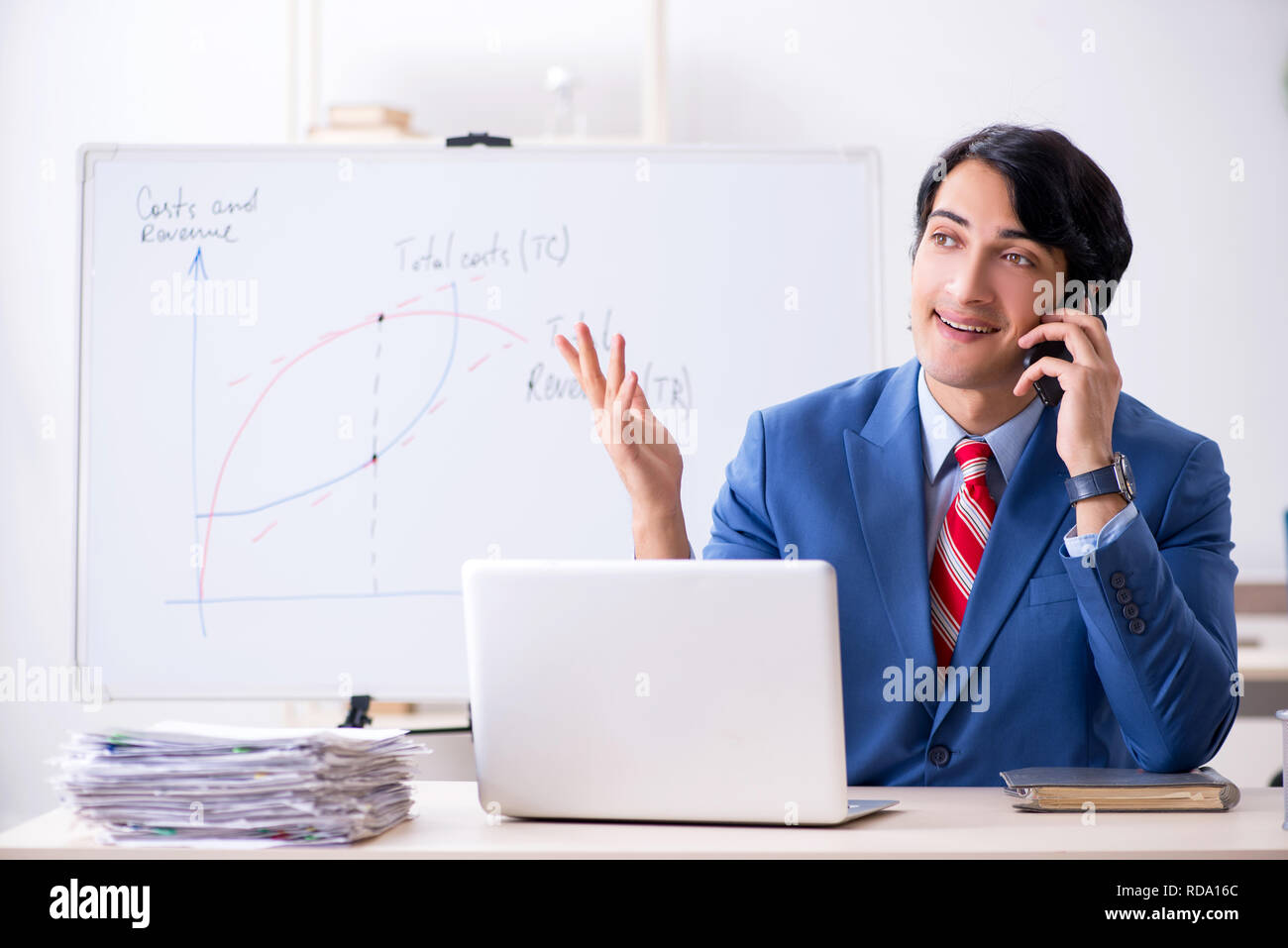 Busy businessman explaining business charts Stock Photo - Alamy