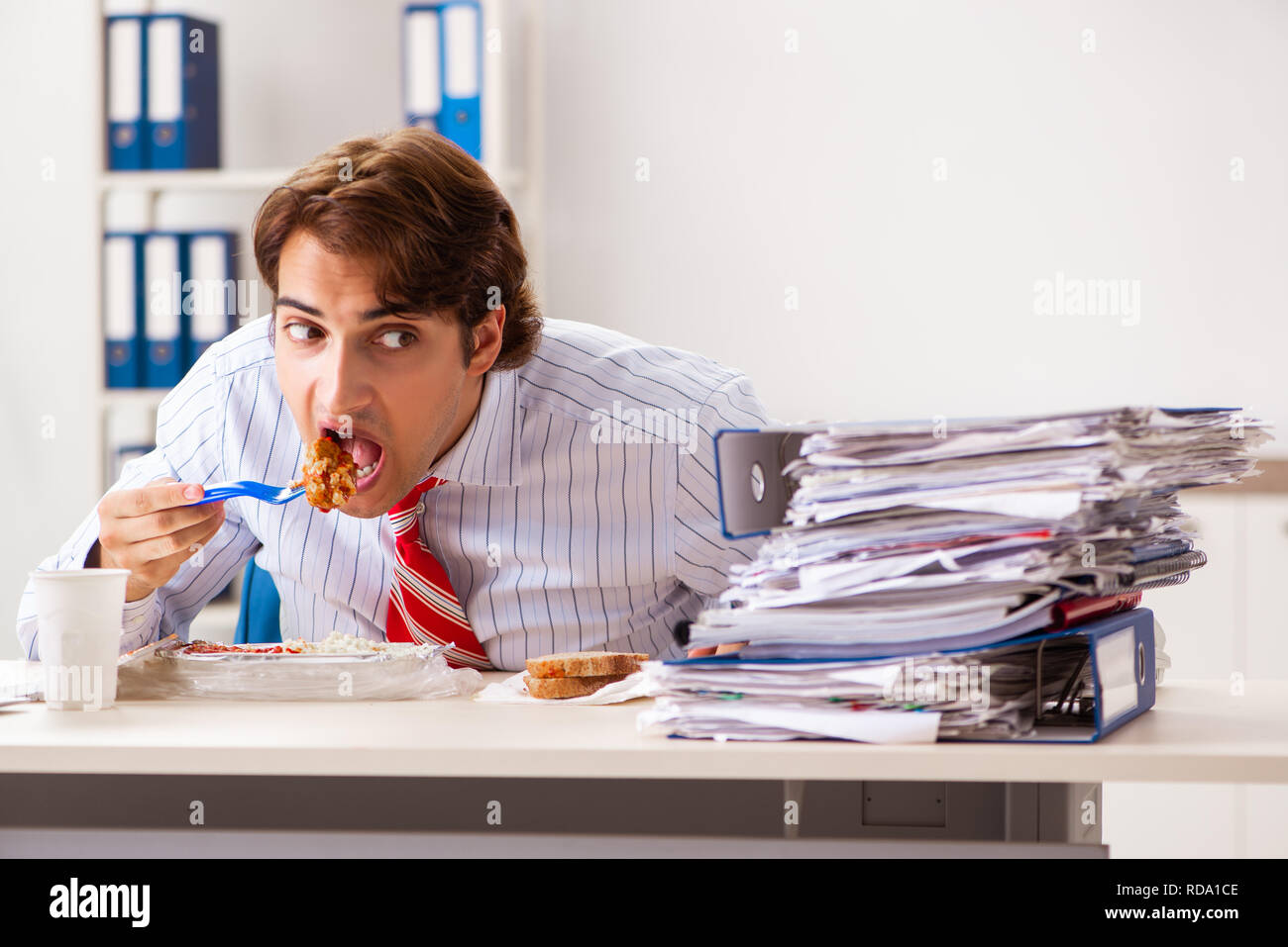 Man having meal at work during break Stock Photo - Alamy