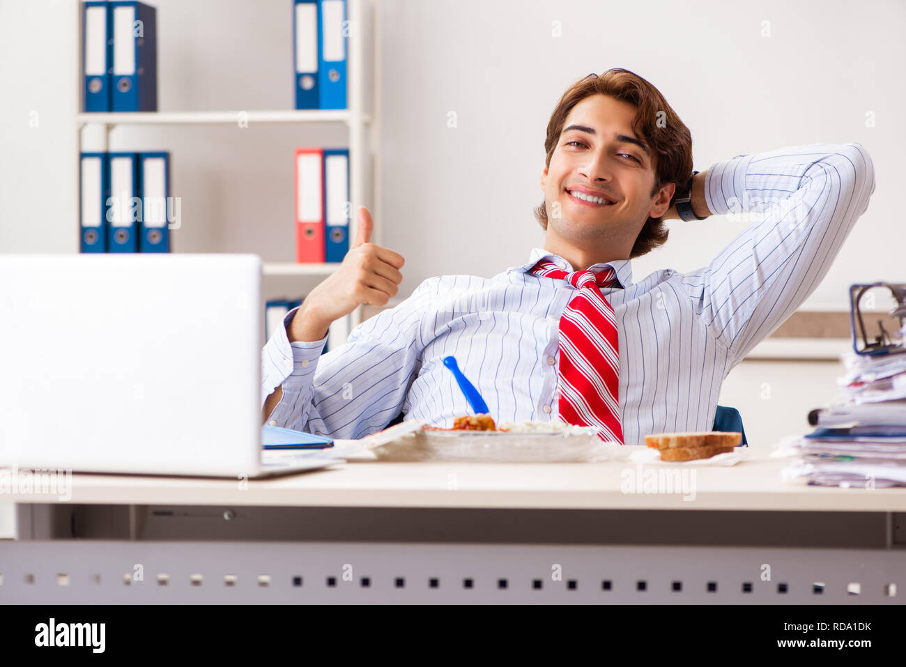 Man having meal at work during break Stock Photo - Alamy