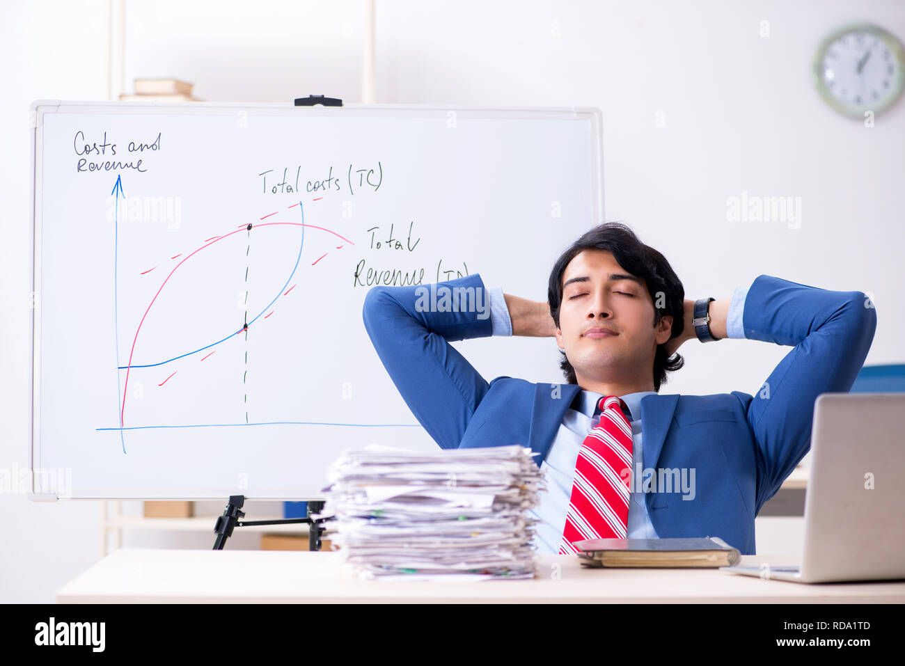 Busy businessman explaining business charts Stock Photo - Alamy