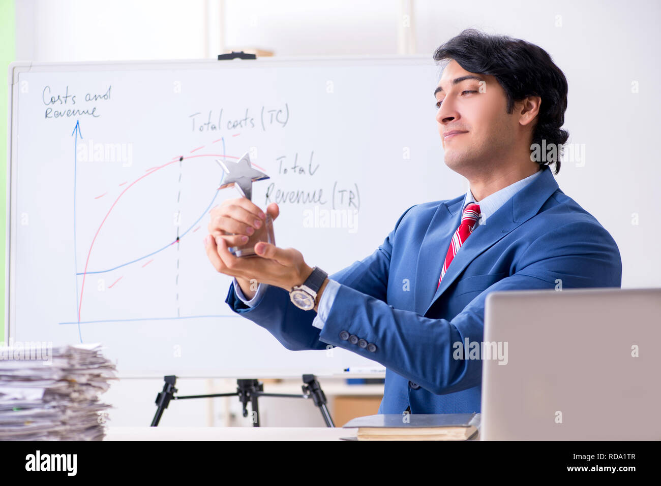 Busy businessman explaining business charts Stock Photo - Alamy