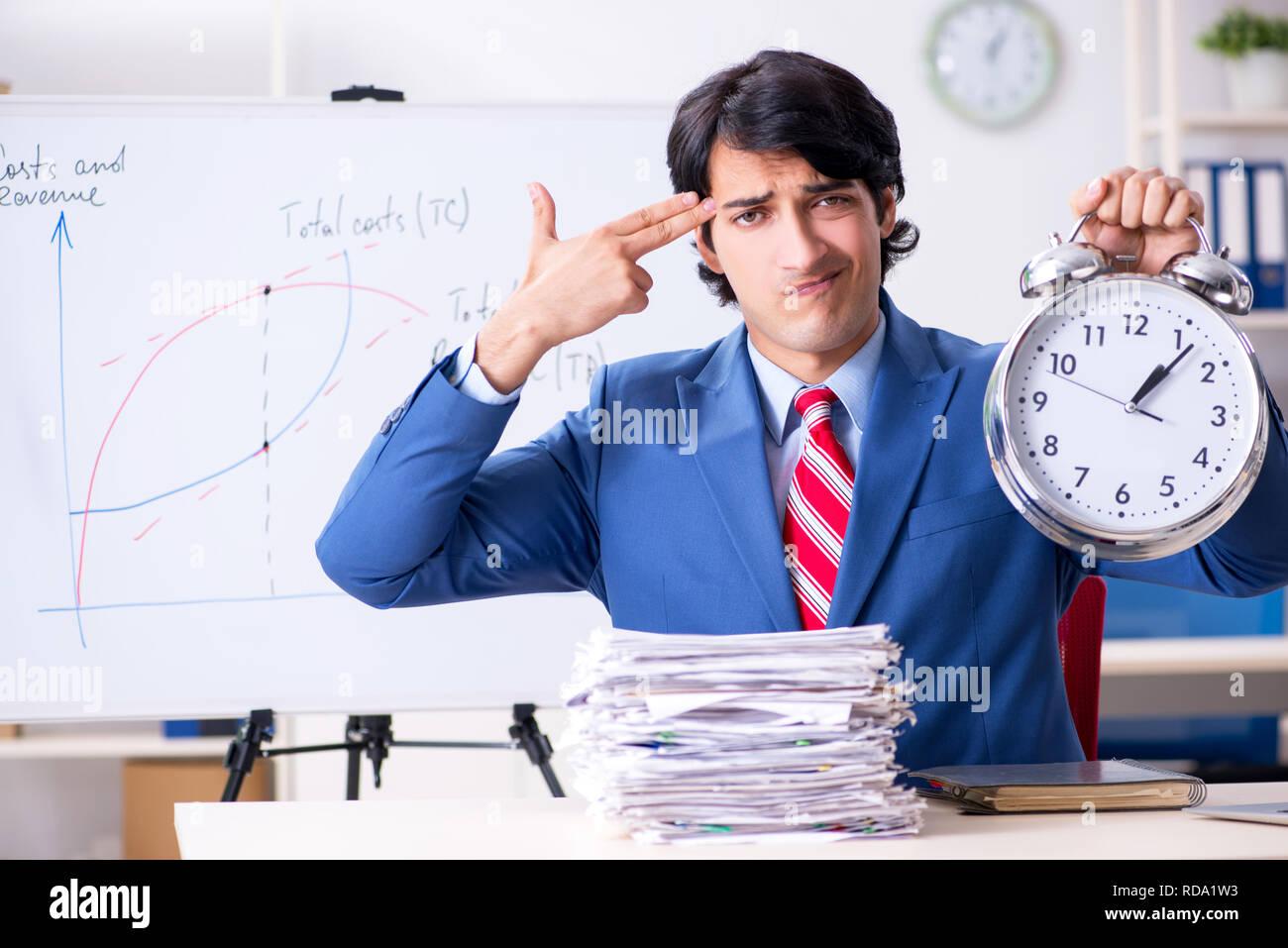 Busy businessman explaining business charts Stock Photo - Alamy