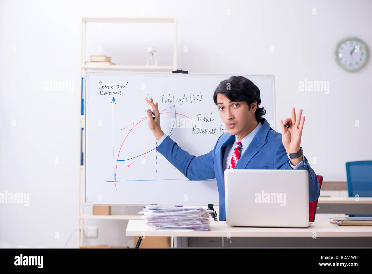 Busy businessman explaining business charts Stock Photo - Alamy
