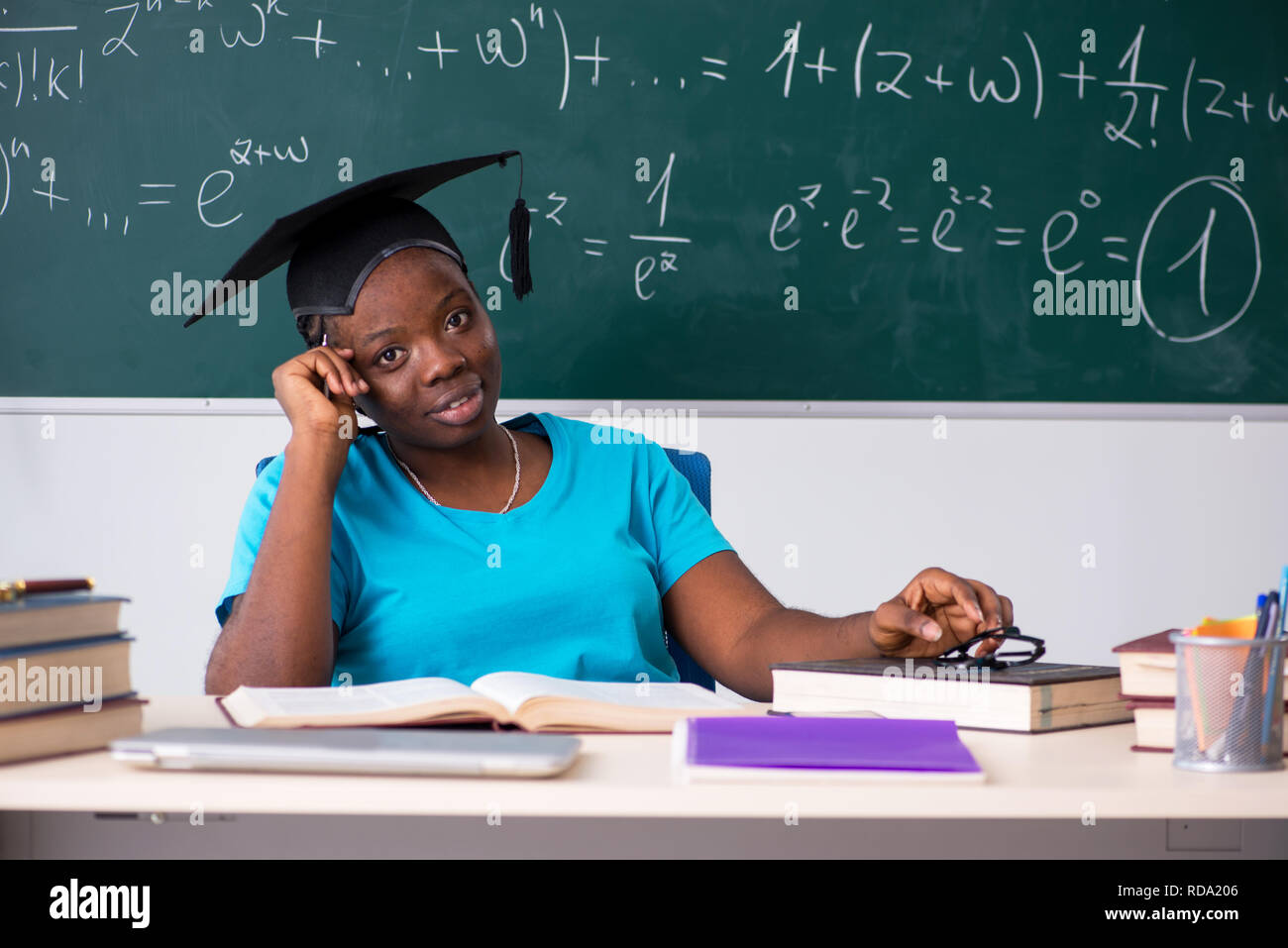Black female student in front of chalkboard Stock Photo - Alamy
