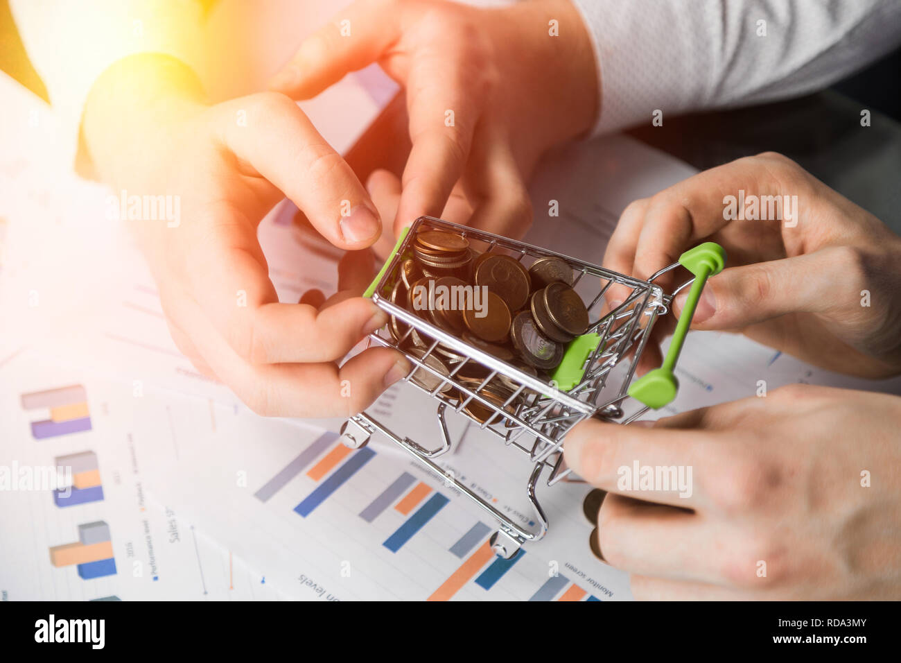 Men's hands pulled in different directions Dummy shopping cart filled ...