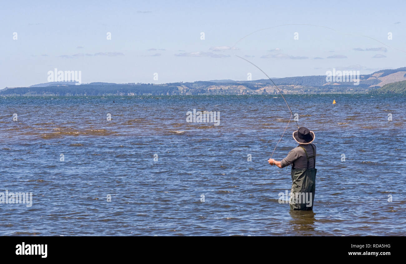 Flyfisher standing in ocean Stock Photo - Alamy