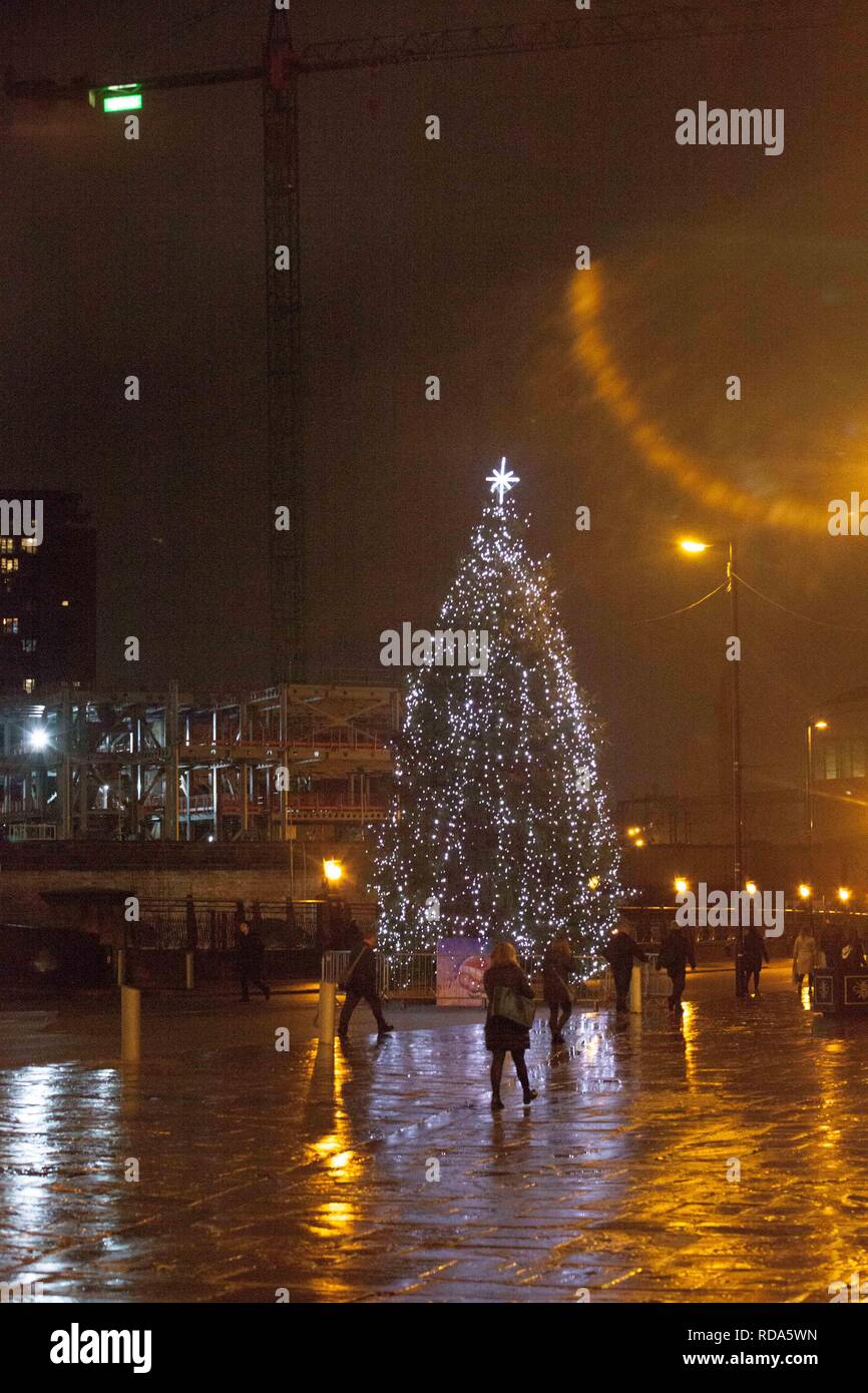Christmas tree with lights on a rainy night in Deansgate at the bottom ...