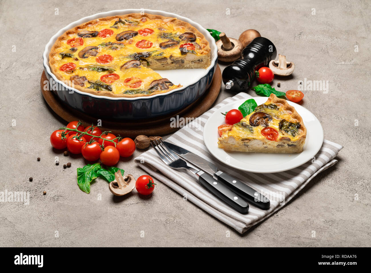Baked homemade quiche pie in ceramic baking form and slice Stock Photo ...