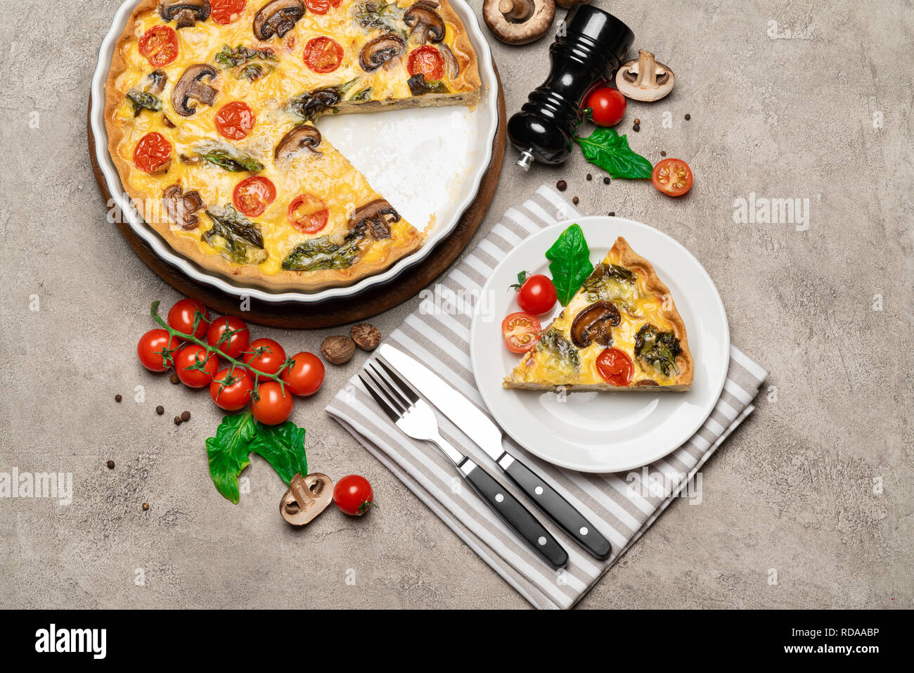 Baked homemade quiche pie in ceramic baking form and slice Stock Photo ...