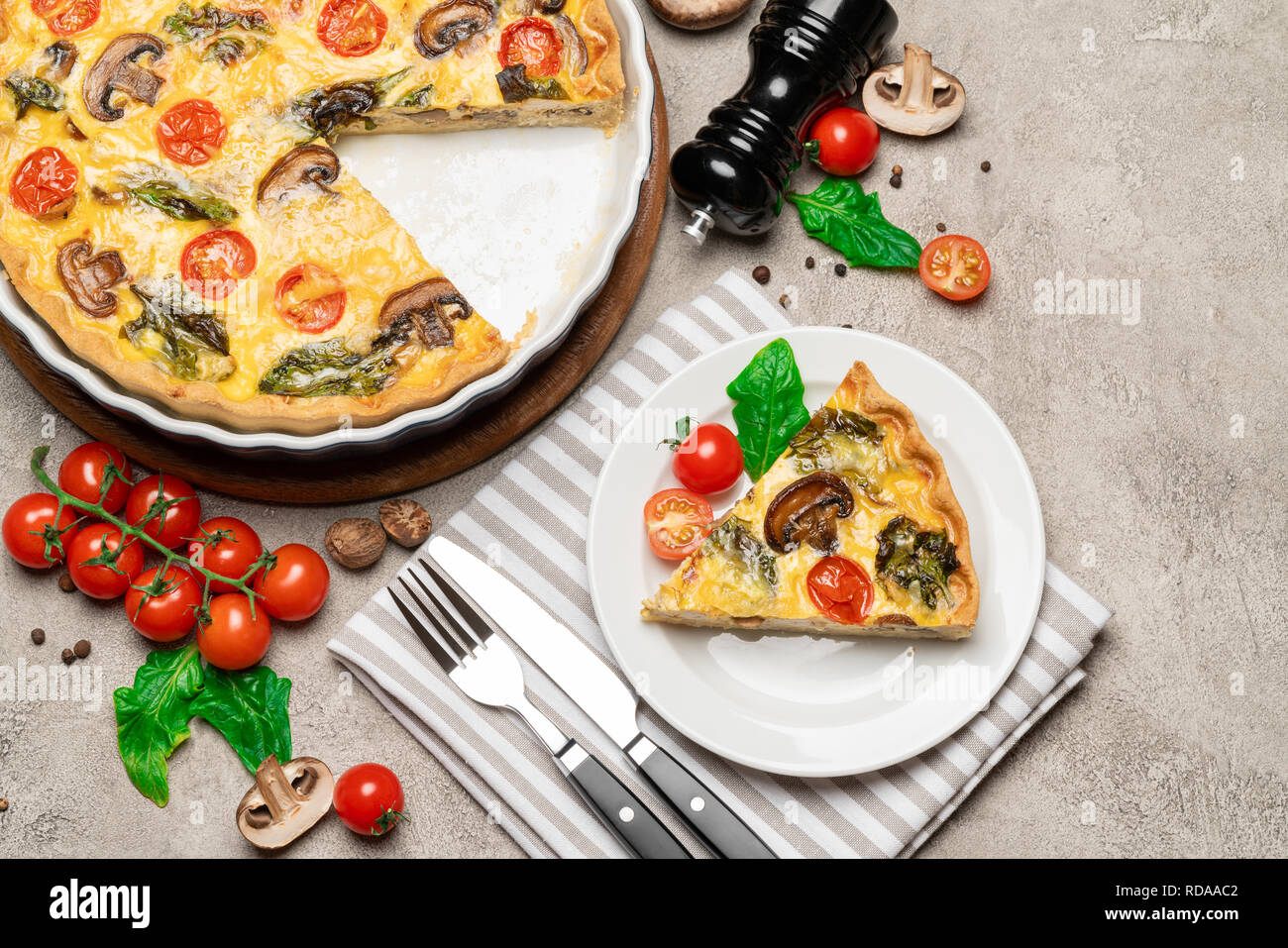 Baked homemade quiche pie in ceramic baking form and slice Stock Photo ...