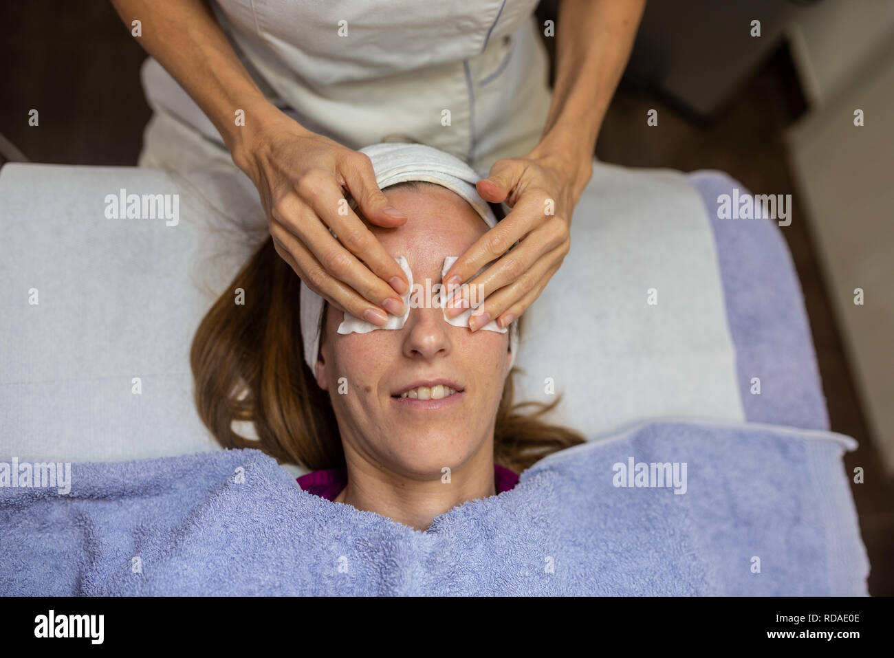 Young woman getting facial treatment hi-res stock photography and ...