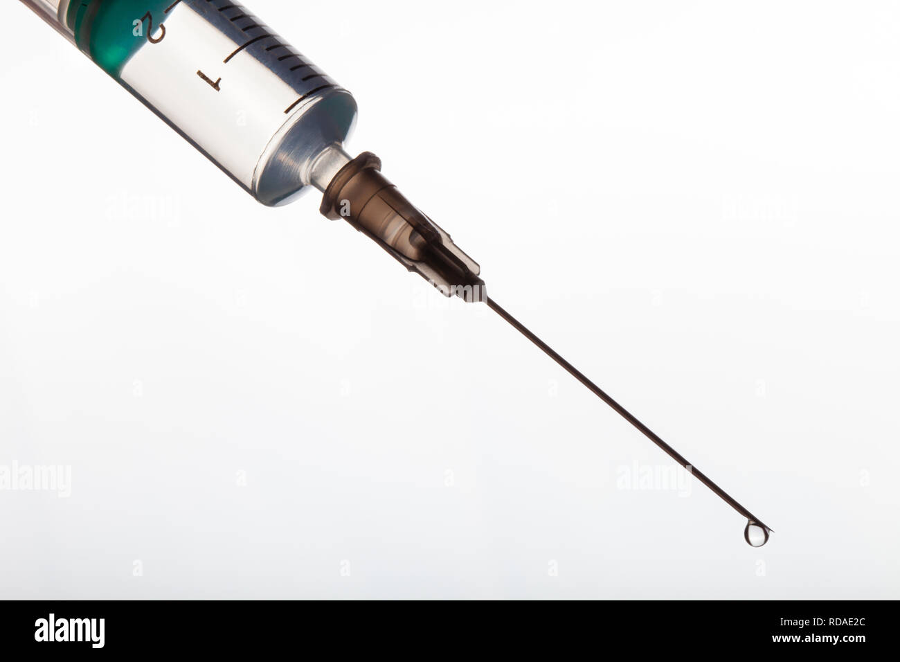 Syringe on white background with bubble on the end of needle , prepared ...