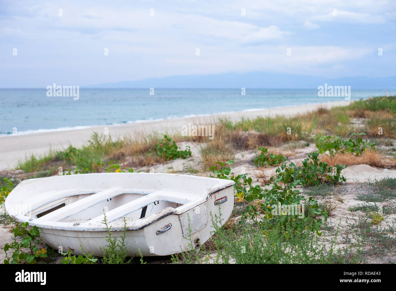Old white boat on a beach. Italy. Calabria Stock Photo - Alamy