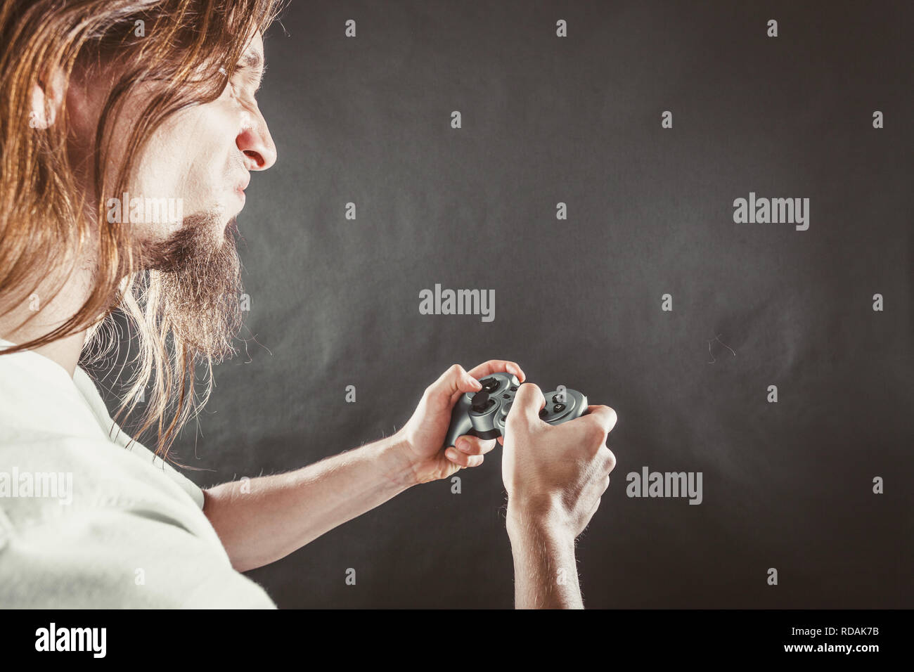 Addiction. Stressed depressed young man playing gaming on pad. Angry ...
