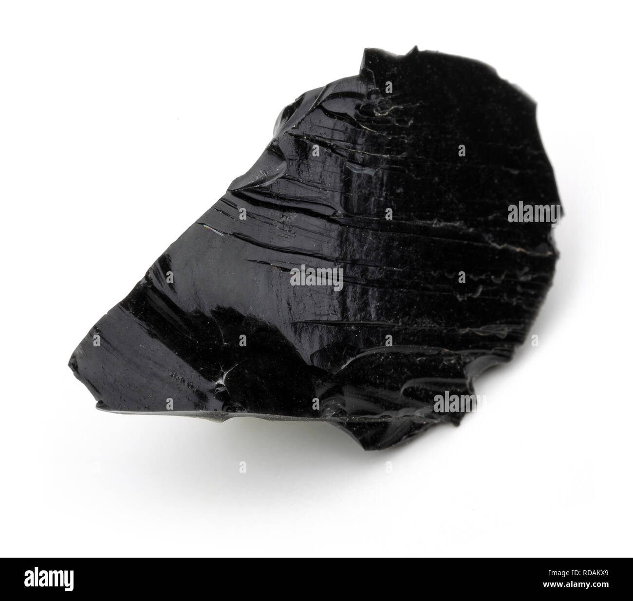 Black obsidian piece isolated on white background Stock Photo - Alamy