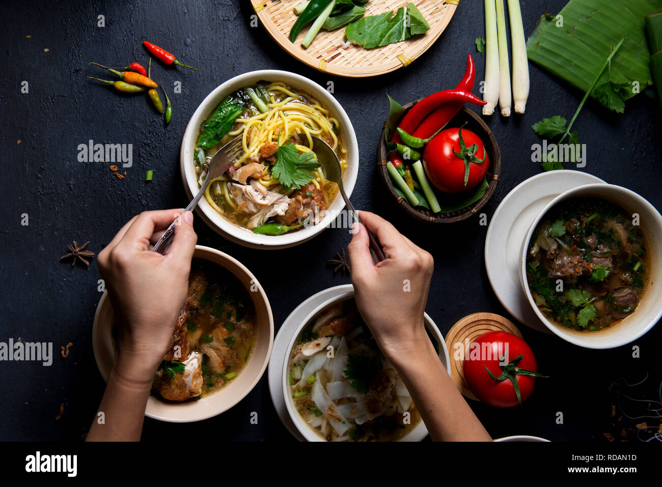 hand indulding on various malay foods Stock Photo - Alamy