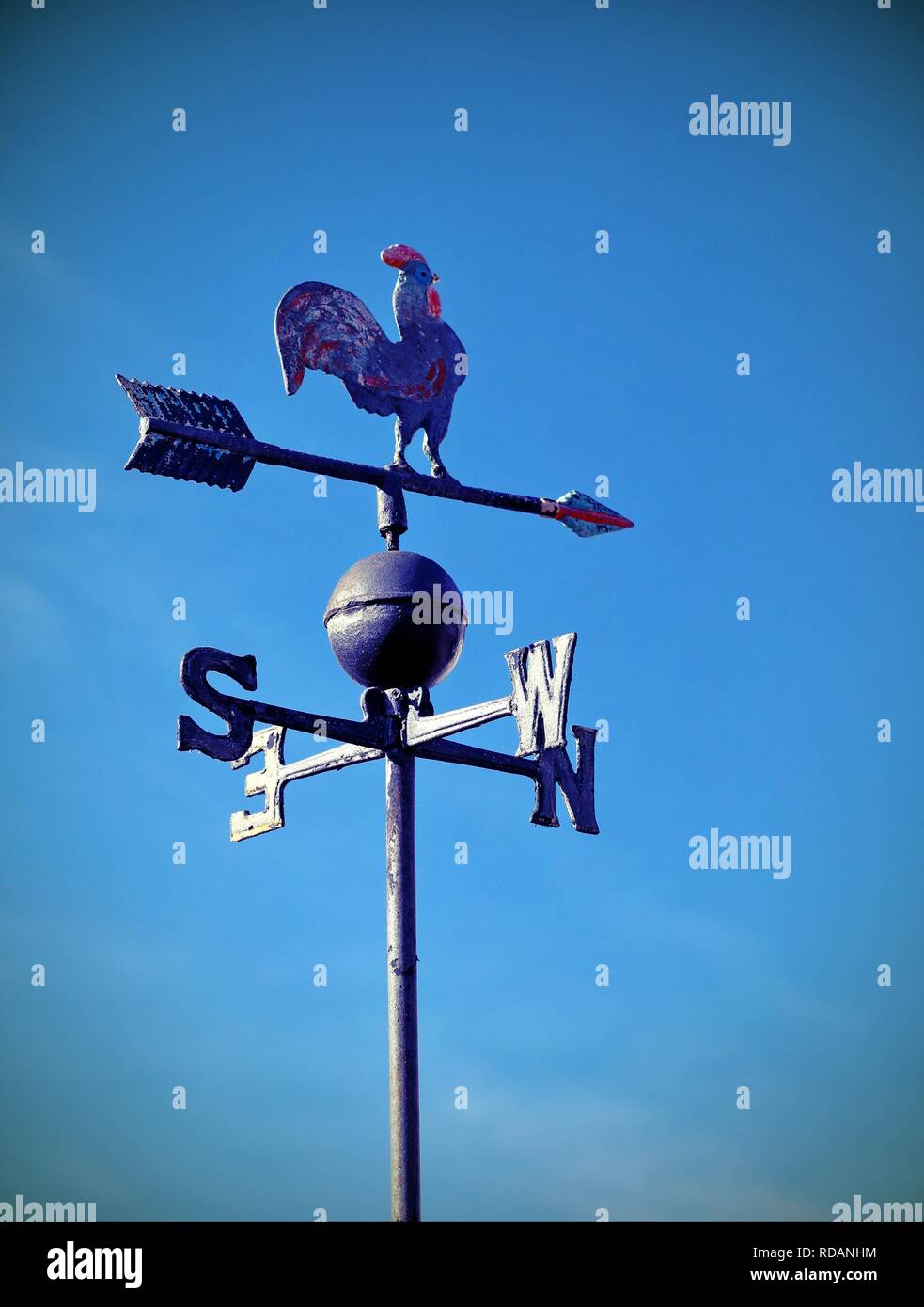 steel vane surmounted by a rooster that indicates the wind direction ...