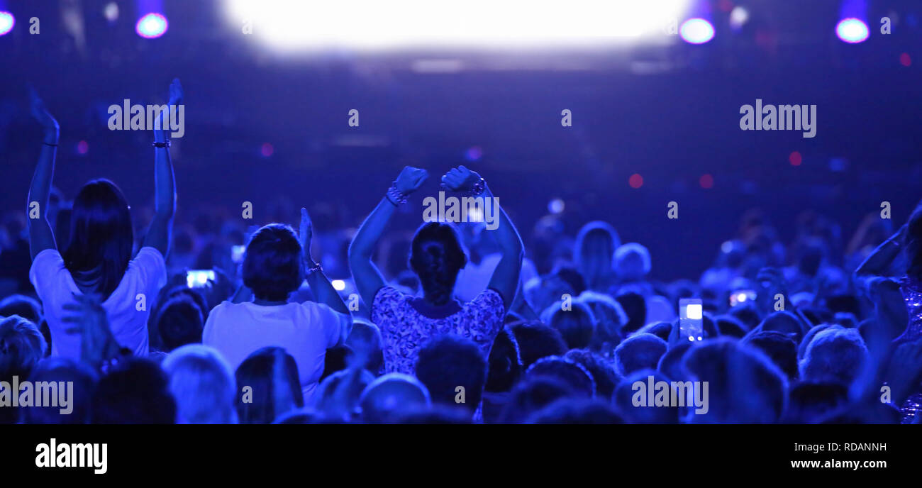 three girls at live concert with many other people Stock Photo - Alamy
