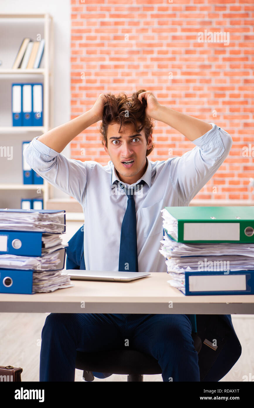 Young elegant man unhappy with too much work Stock Photo - Alamy