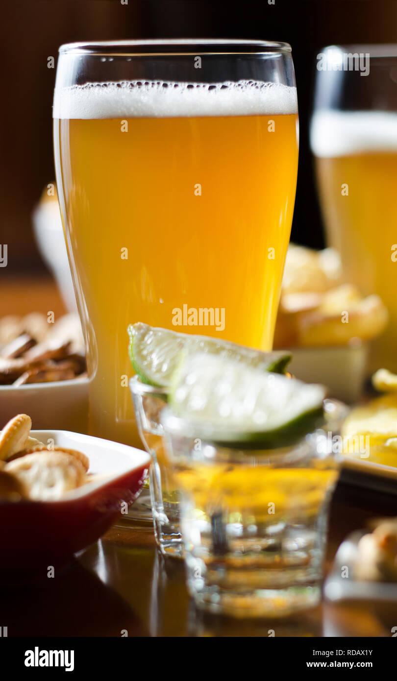 pint of lager beer in a glass, set of various snacks, a standard set of ...