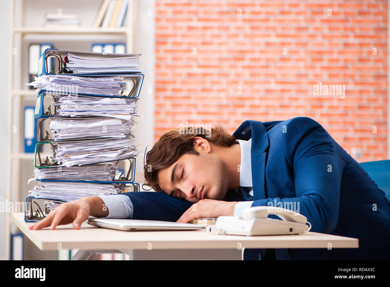 Young elegant man unhappy with too much work Stock Photo - Alamy