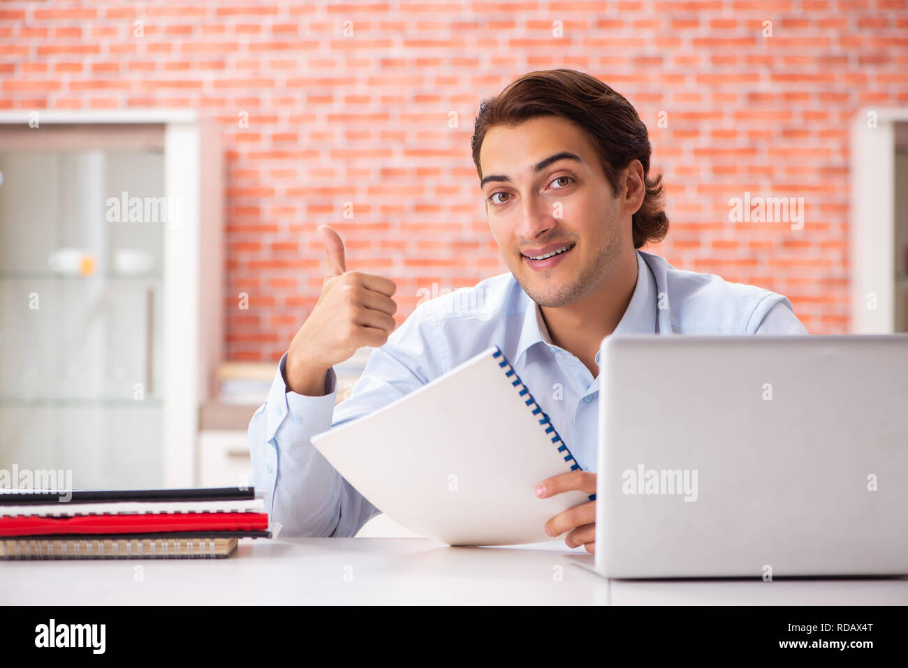 Young handsome employee working in the office Stock Photo - Alamy