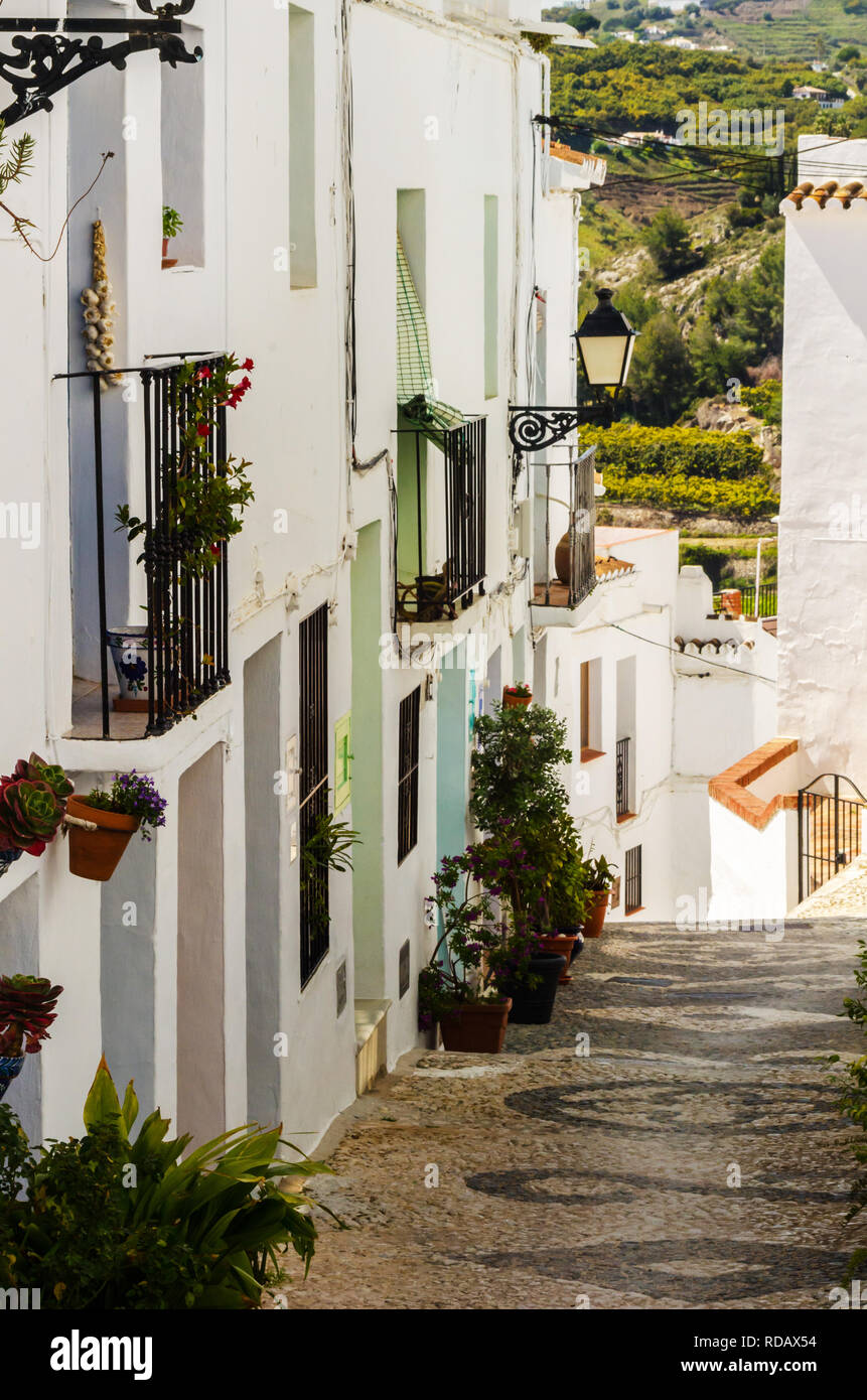 beautiful and picturesque narrow street with white facades of buildings ...