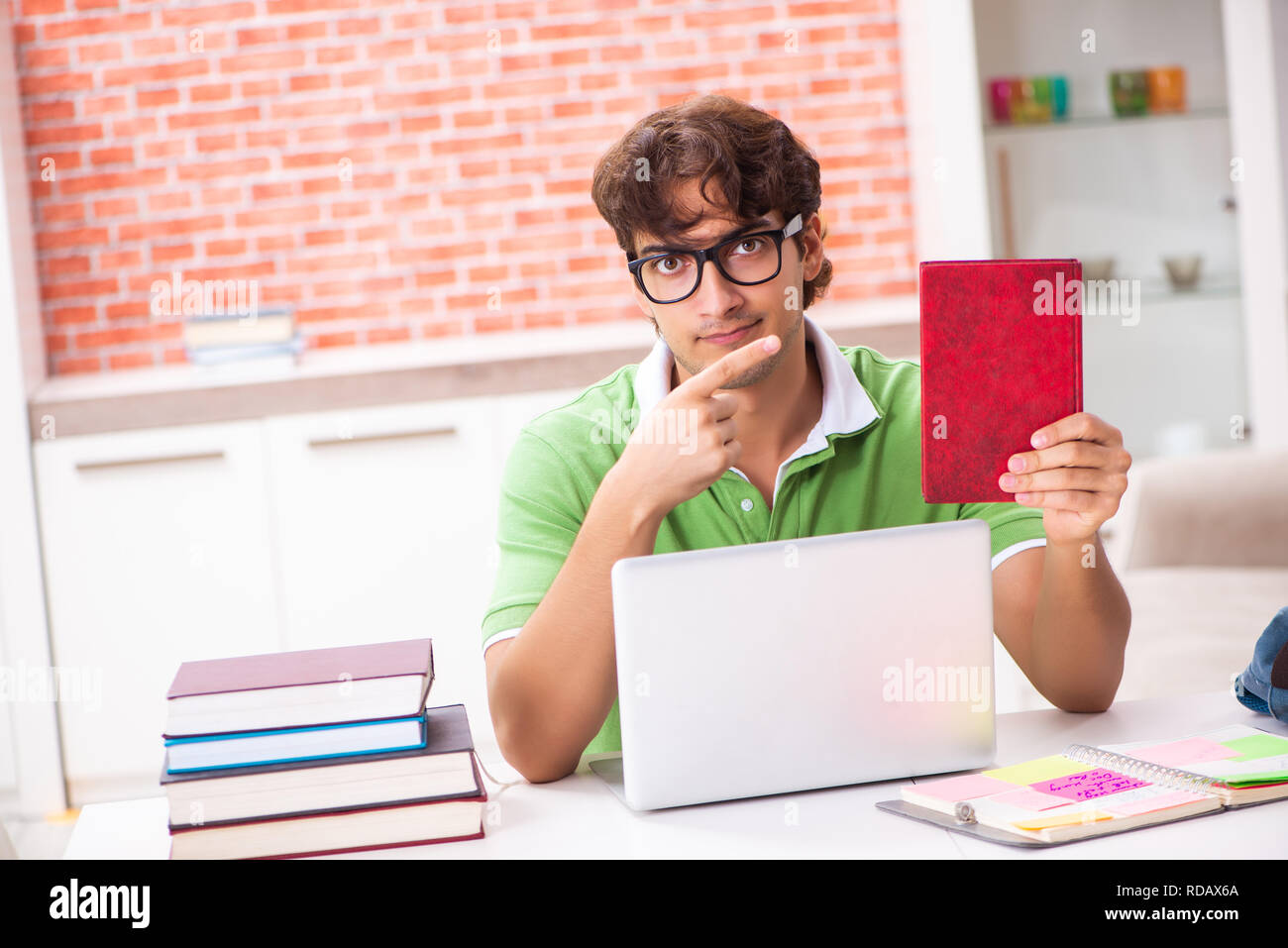Teenager revising laptop books at home hi-res stock photography and ...