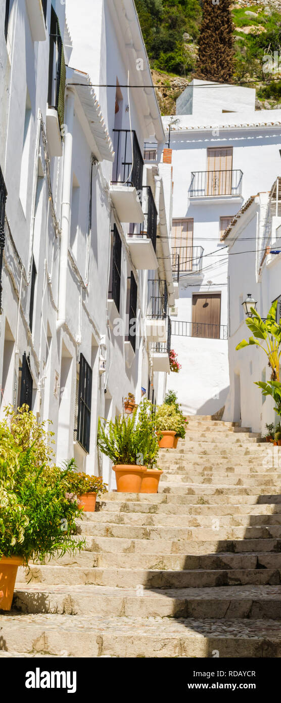 beautiful and picturesque narrow street with white facades of buildings ...