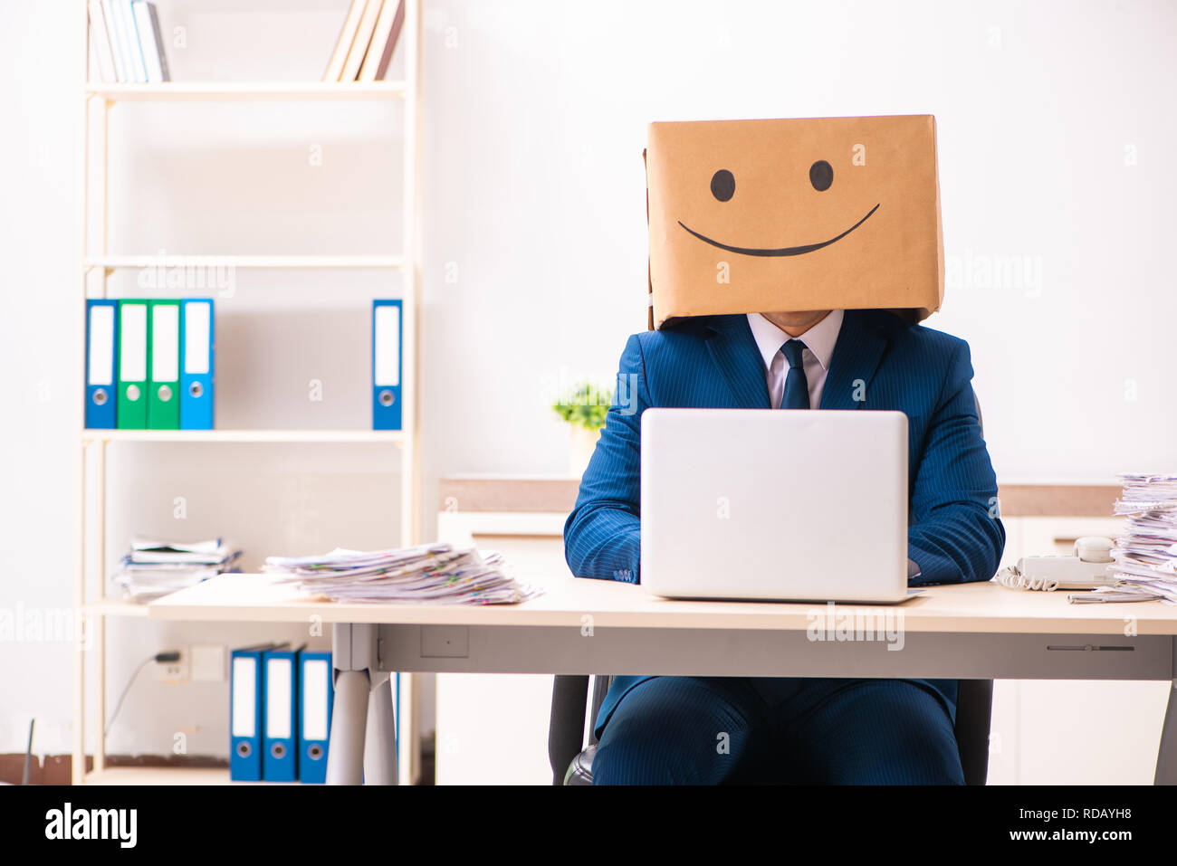 Happy man employee with box instead of his head Stock Photo - Alamy