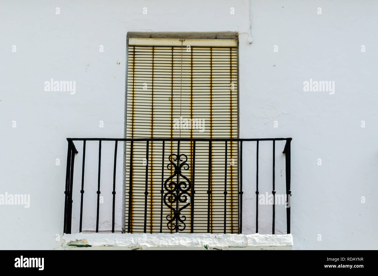 Stylish balcony with a metal railing, solid architectural element, a ...