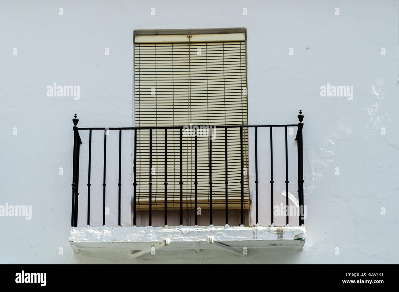 Stylish balcony with a metal railing, solid architectural element, a ...
