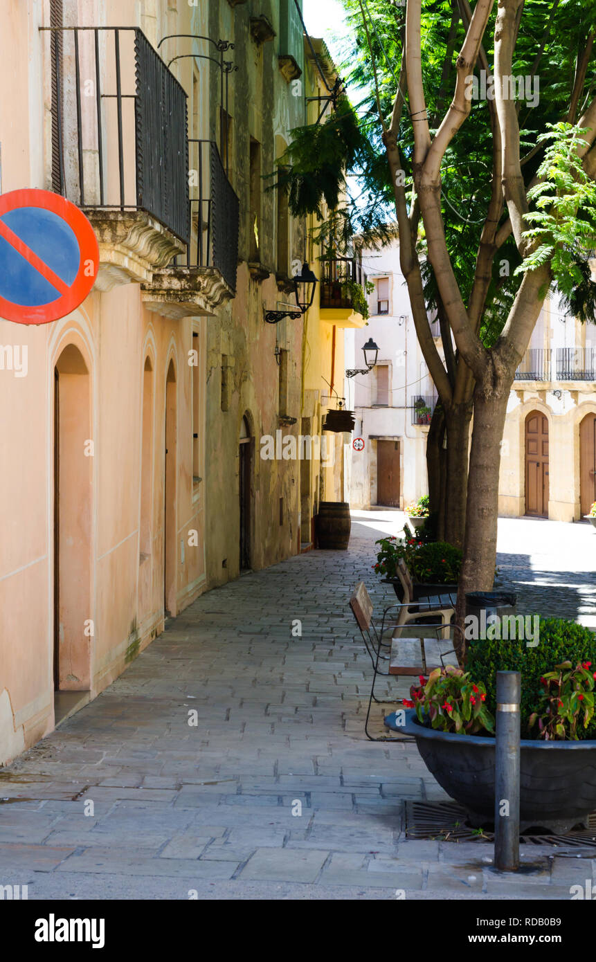 beautiful and picturesque narrow street with white facades of buildings ...
