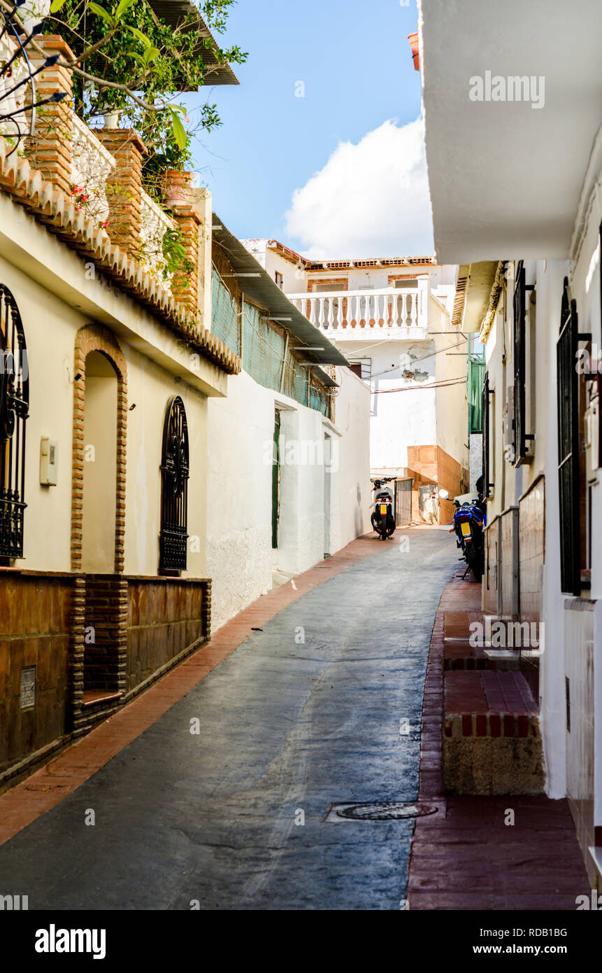 beautiful and picturesque narrow street with white facades of buildings ...