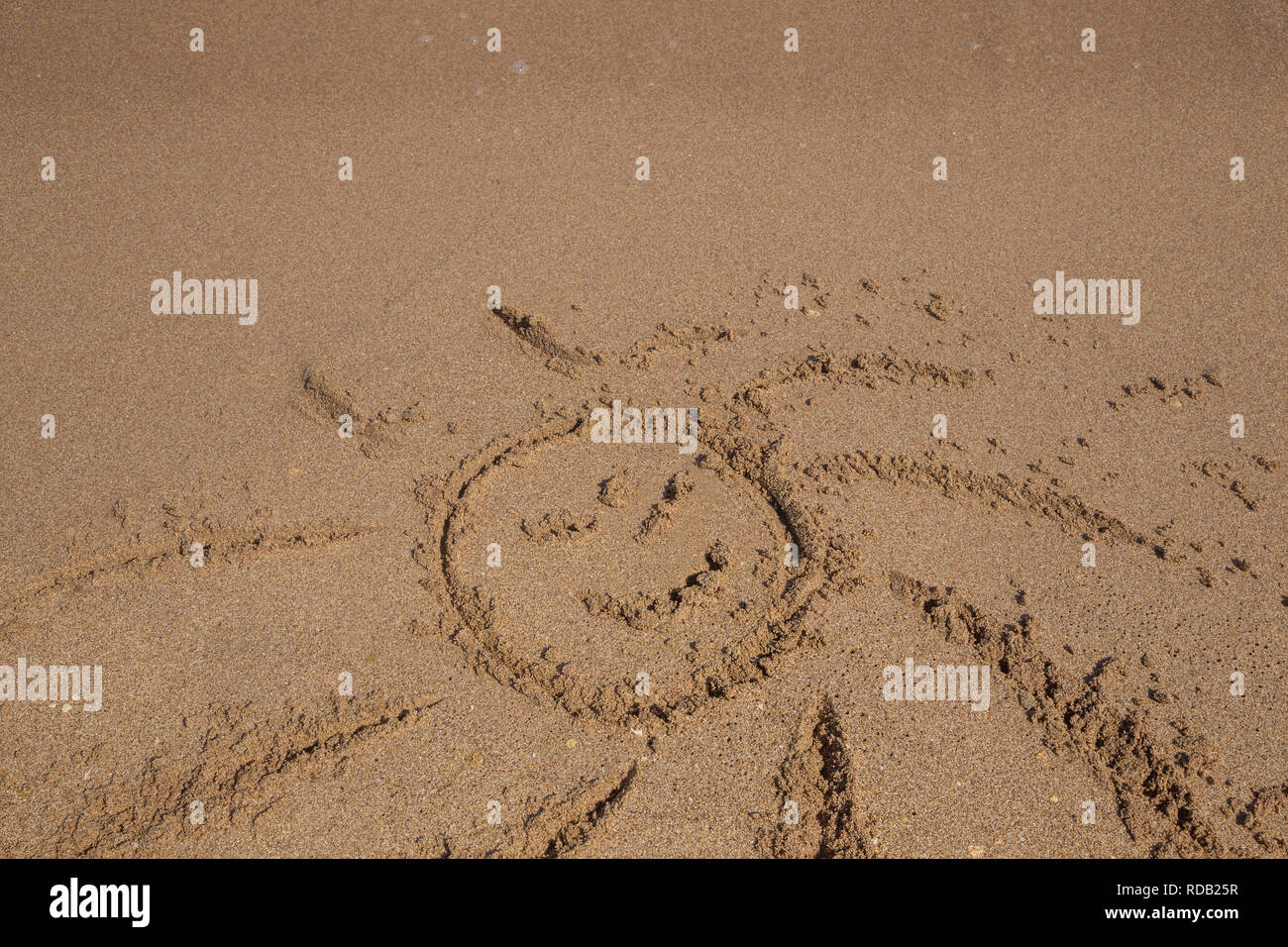summer background with hand drawn sun shape on a sandy beach Stock ...