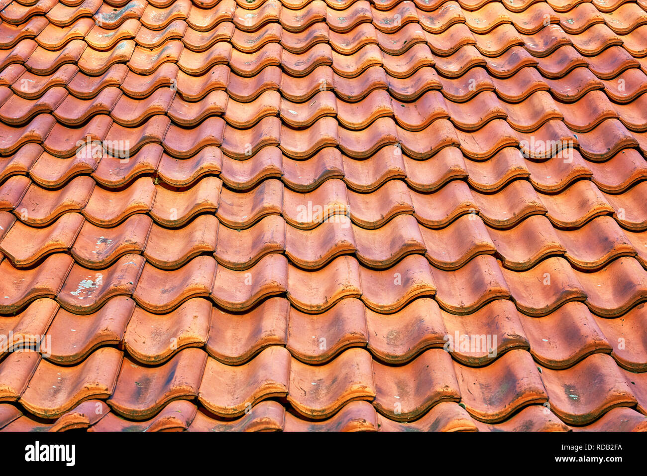 Red tile roof as a background Stock Photo - Alamy