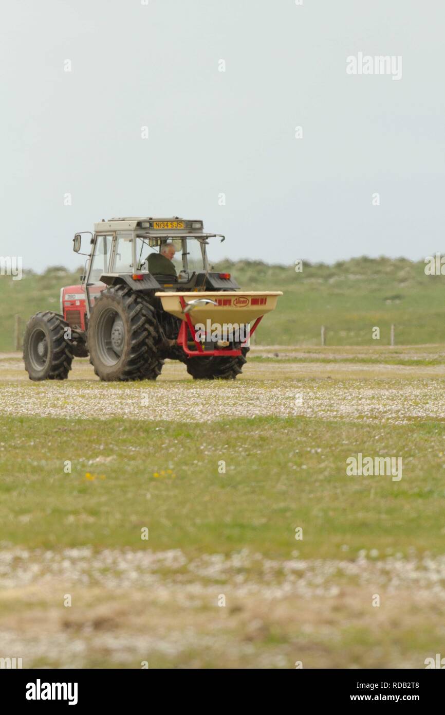 Machir being fertilized to improve it for agricultural production by ...