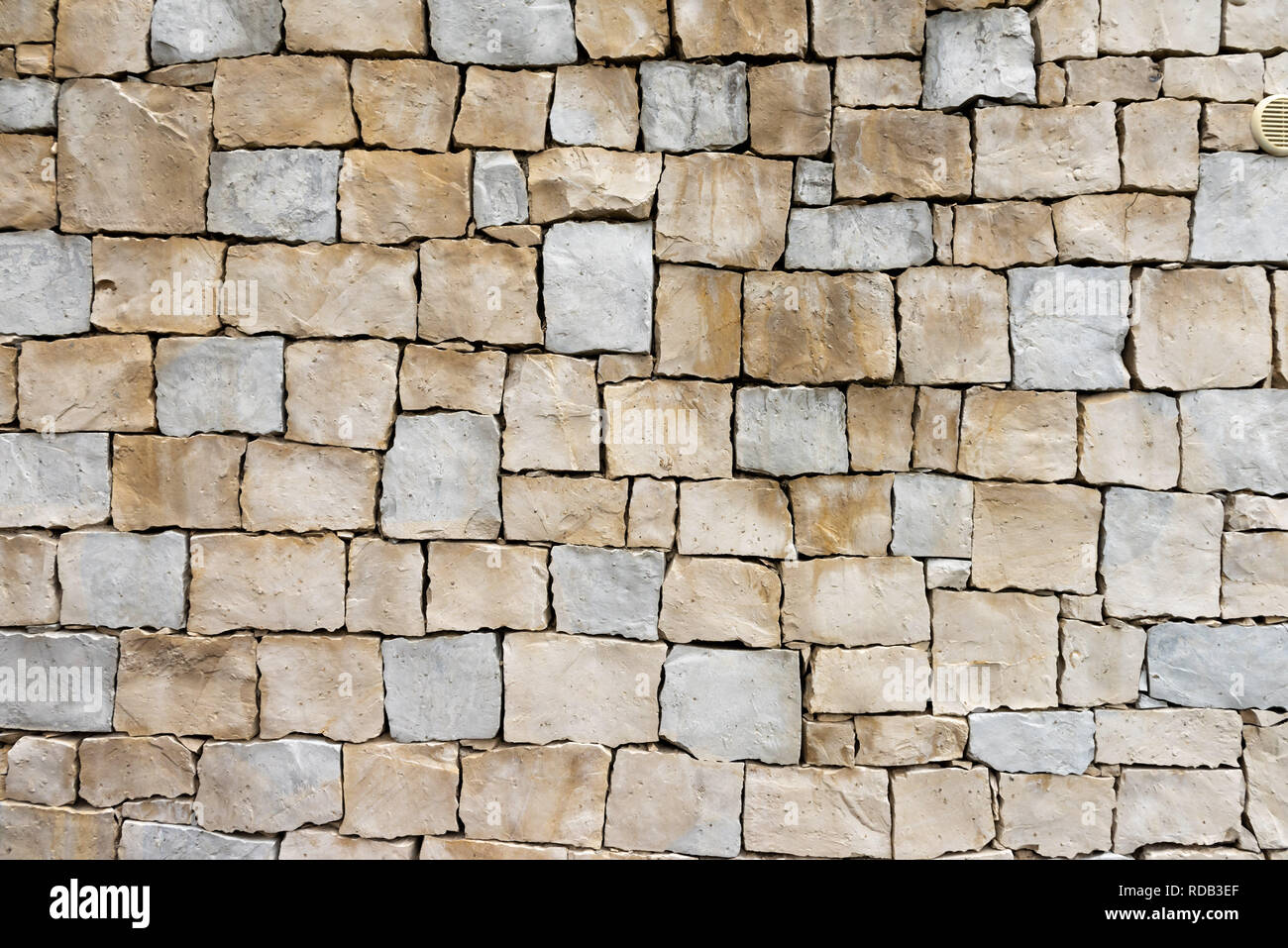 Light warm yellow sandstone wall made of square blocks Stock Photo - Alamy