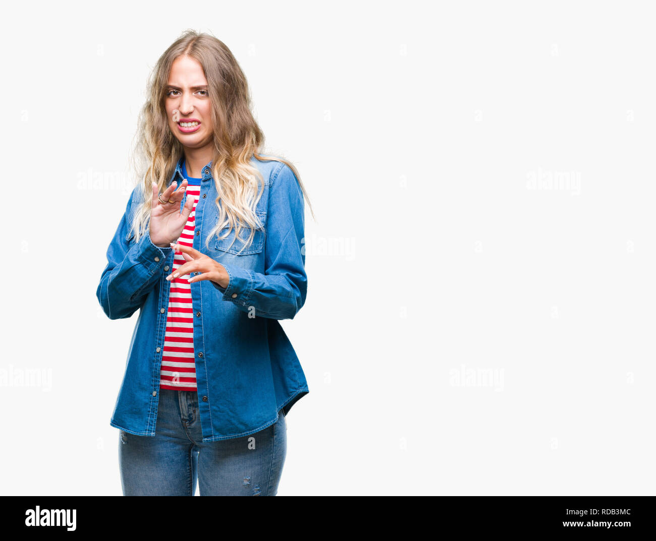 Beautiful young blonde woman over isolated background disgusted ...