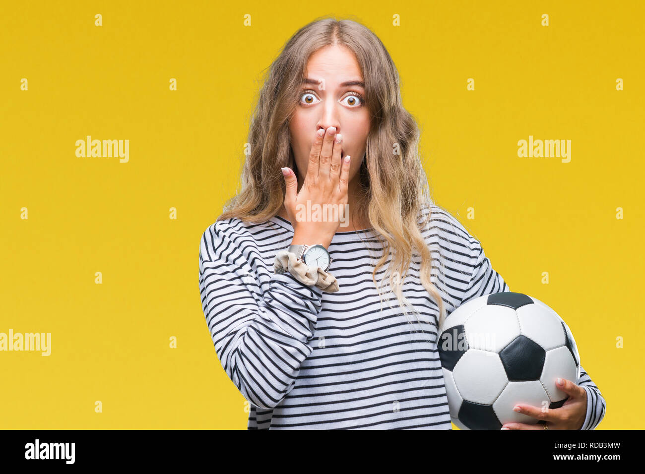 Beautiful young blonde woman holding soccer football ball over isolated ...