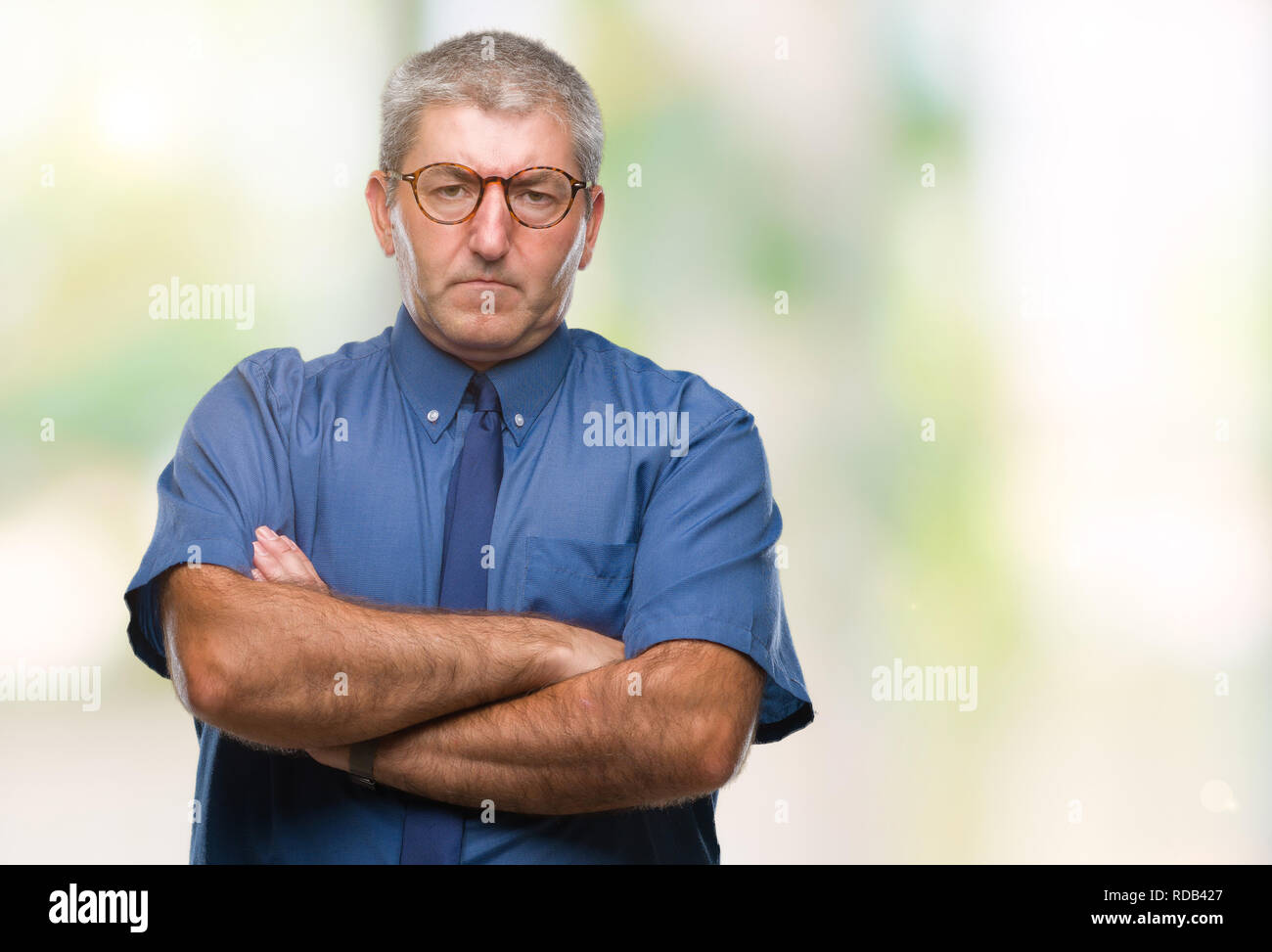 Handsome senior business man over isolated background skeptic and ...