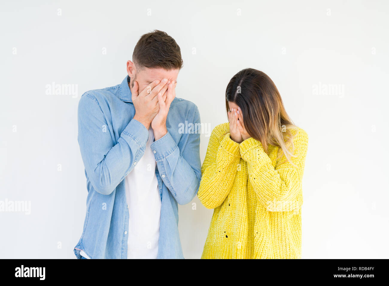 Young beautiful couple togheter over isolated background with sad ...