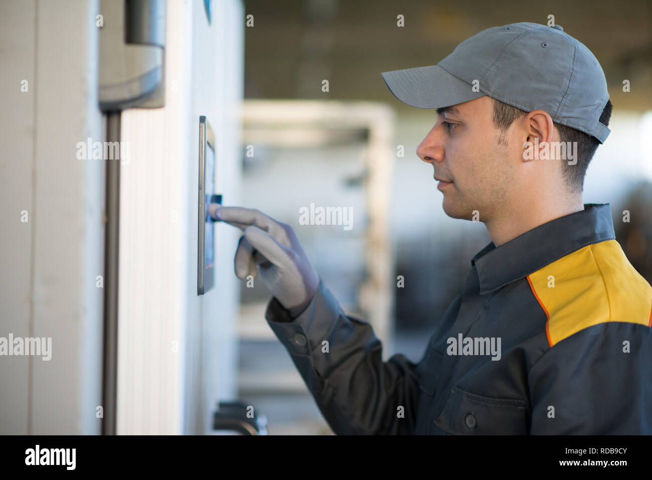 Worker using a touchscreen in an industrial factory Stock Photo - Alamy