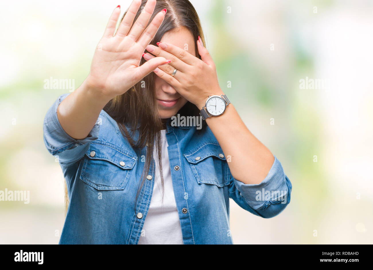 Young caucasian beautiful woman over isolated background covering eyes ...