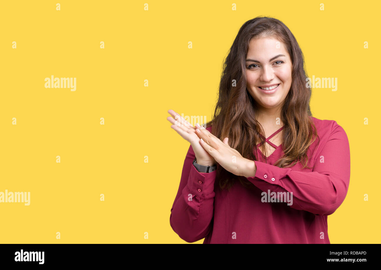 Beautiful plus size young woman over isolated background Clapping and ...