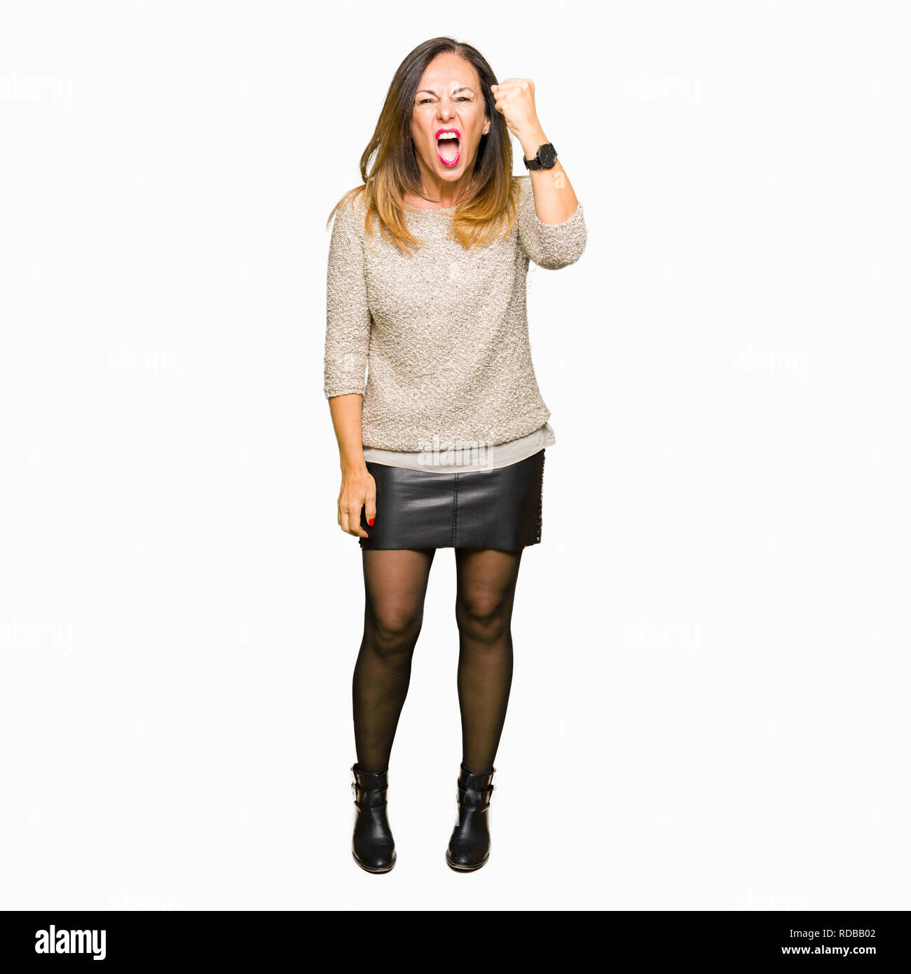 Beautiful middle age woman wearing fashion sweater angry and mad ...