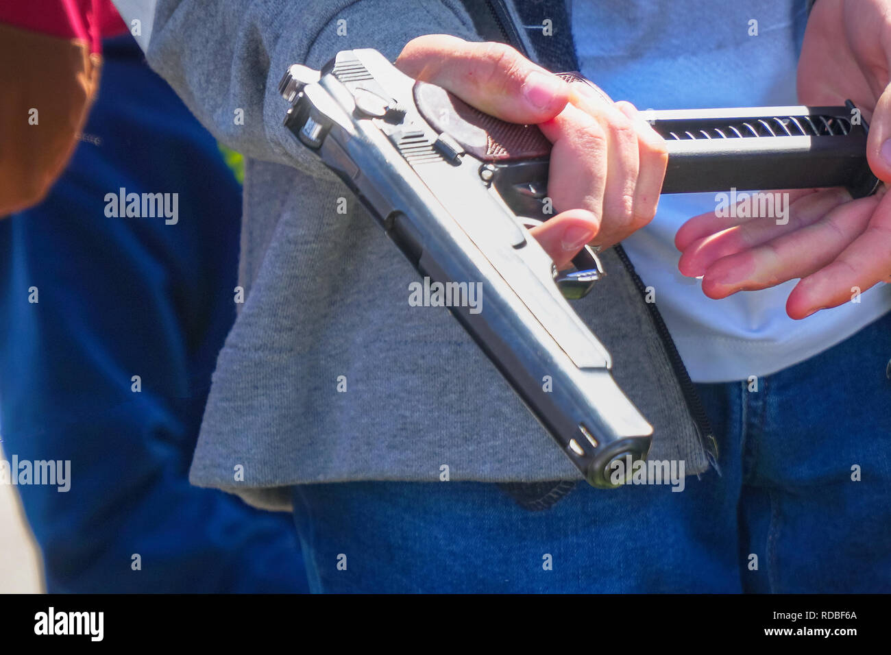 Mans hand holding gun hi-res stock photography and images - Alamy