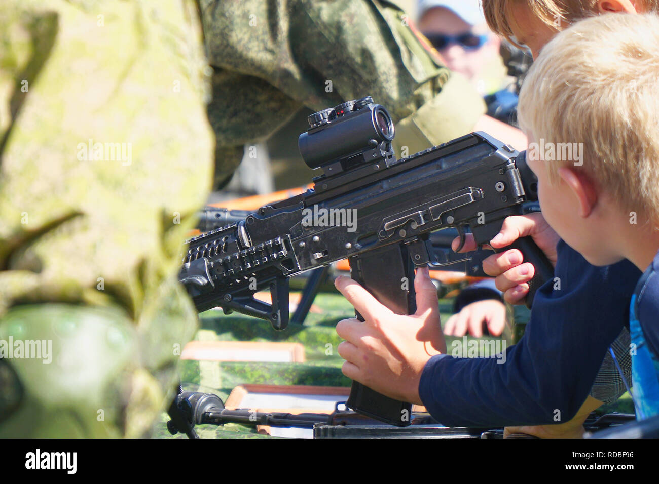Children's hands on a rifle or machine gun Stock Photo - Alamy
