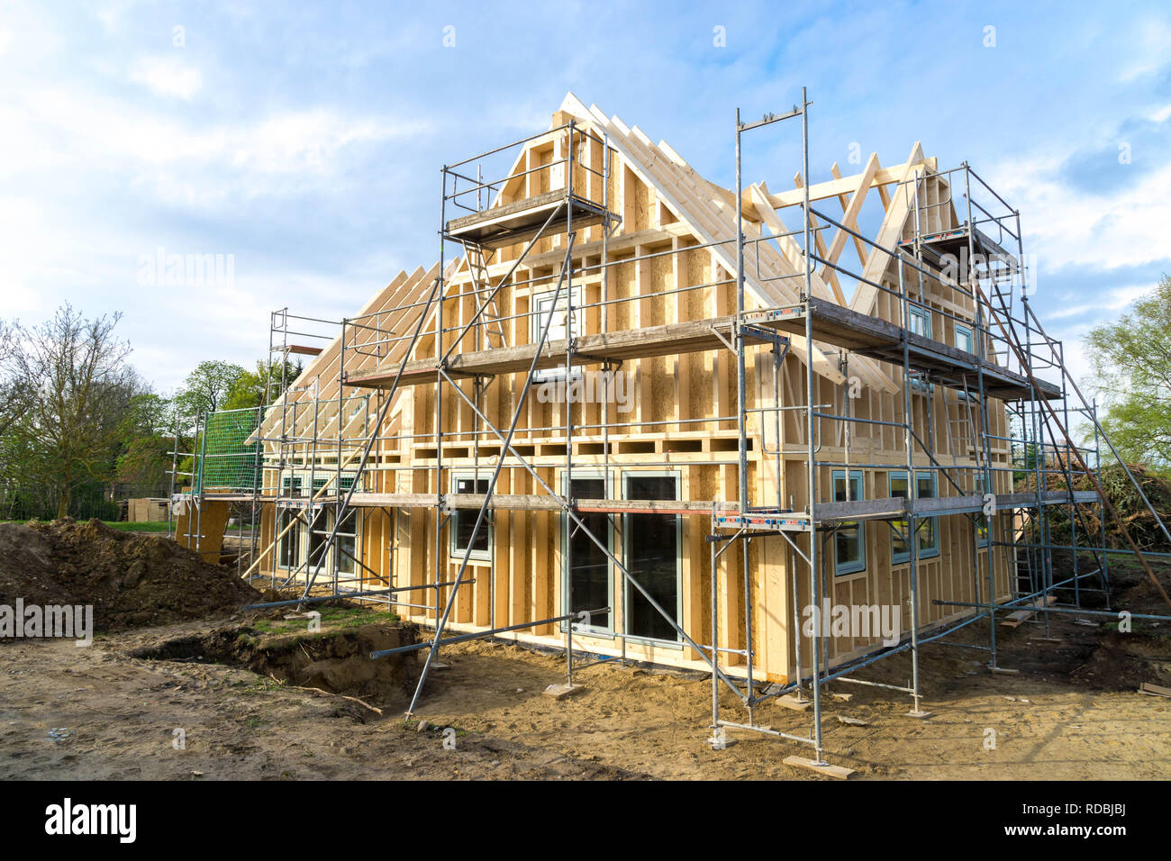 construction site of a wooden house - wood frame with scaffolding at ...